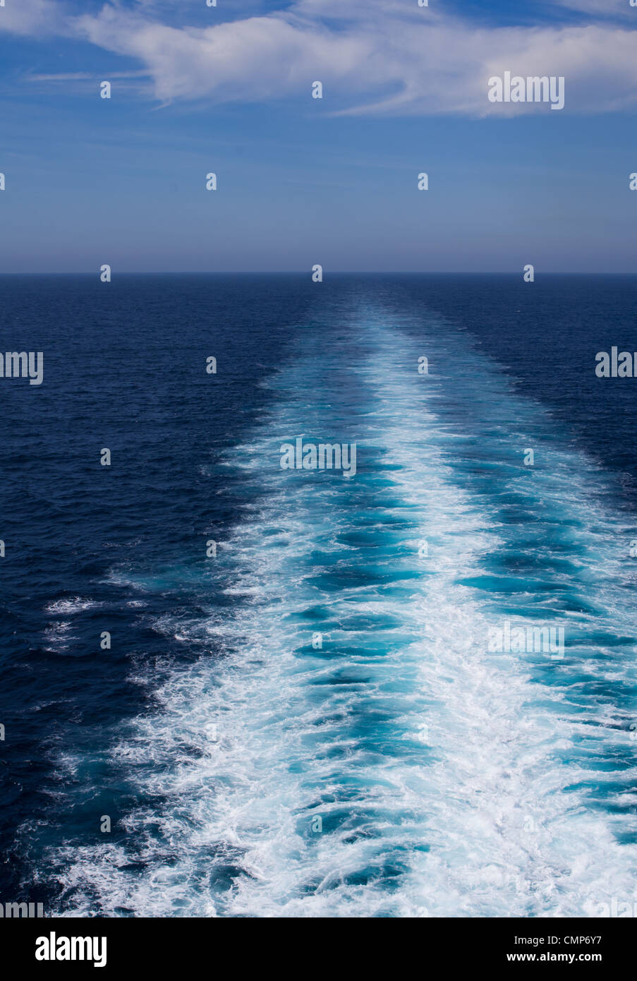 The white wake of a ship contrasts with the blue ocean Stock Photo - Alamy