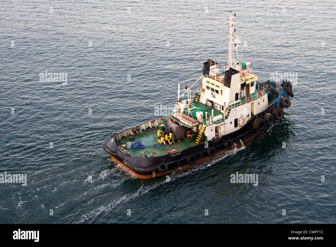 A tug boat ready to help ships in the harbor Stock Photo - Alamy