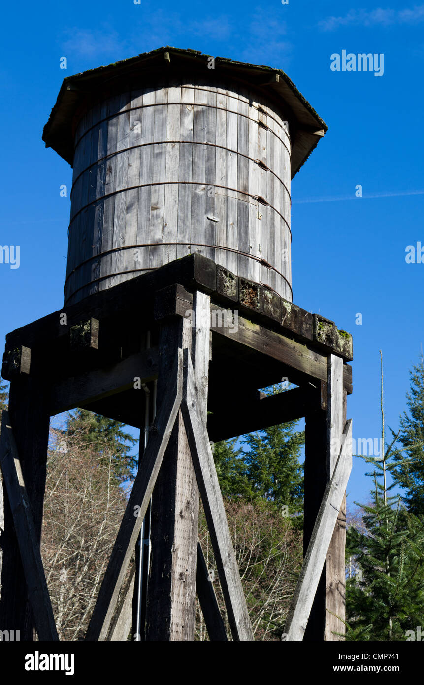 An old wooden water tower under a bright blue sky Stock Photo - Alamy
