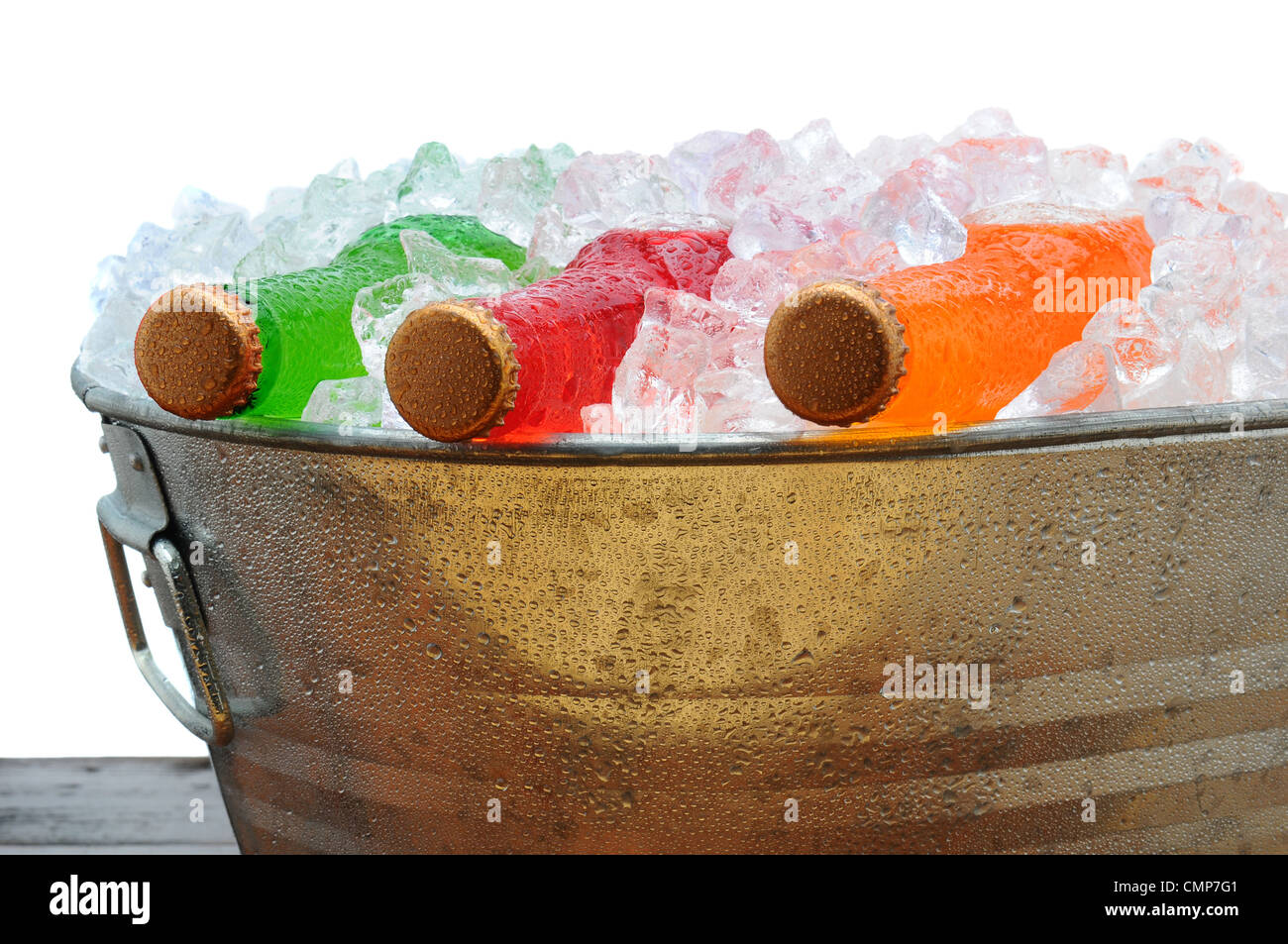 Closeup of assorted soda bottles in a metal party bucket filled with ...
