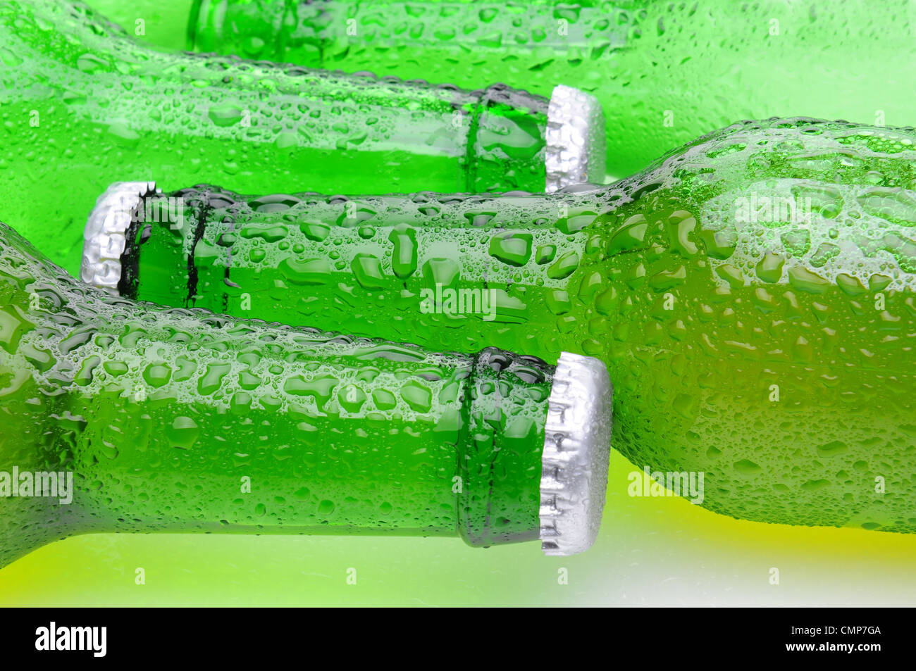 Closeup of green beer bottles laying on their side in horizontal format ...