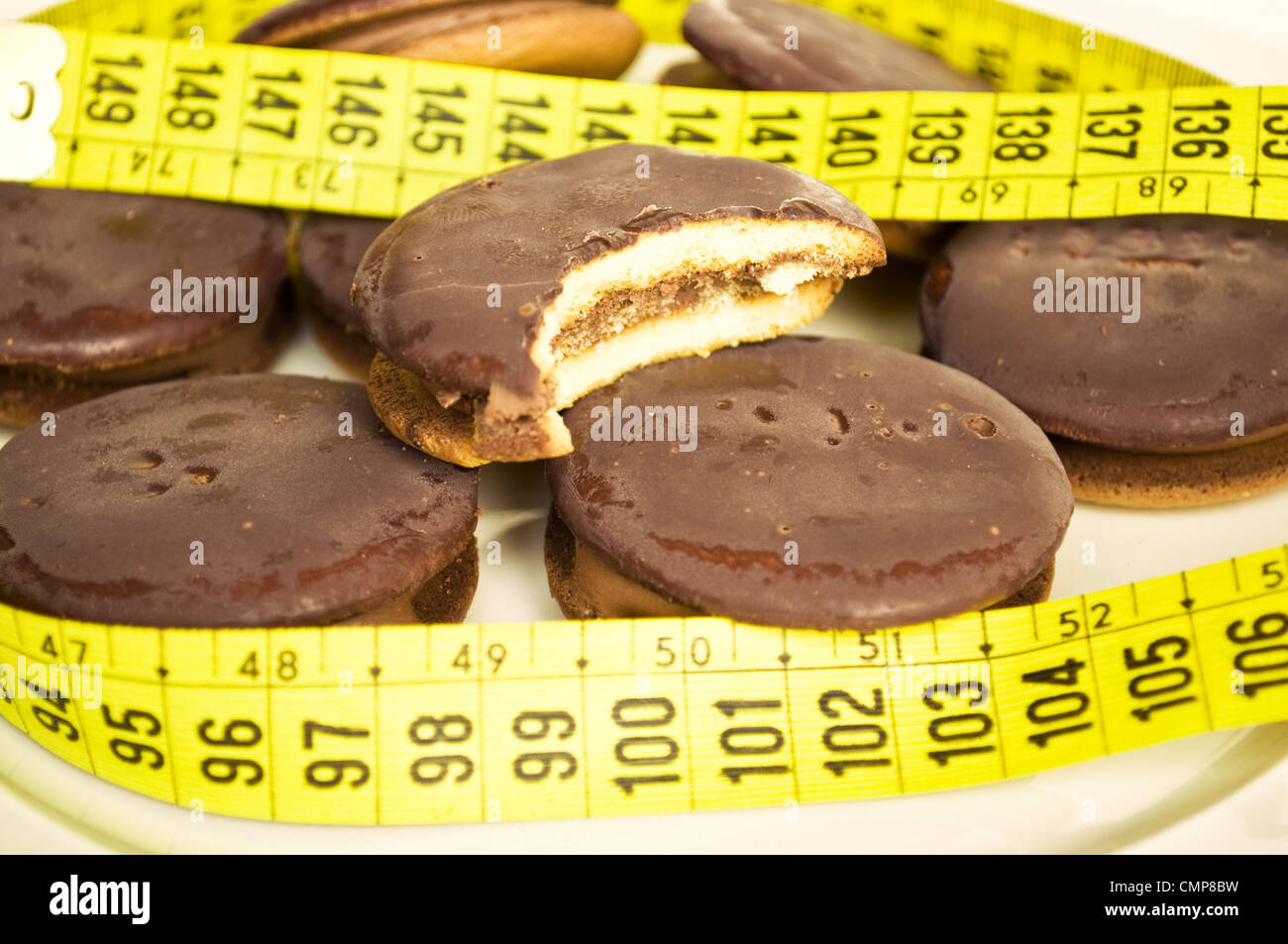 Chocolate cookies and measure tape Stock Photo - Alamy