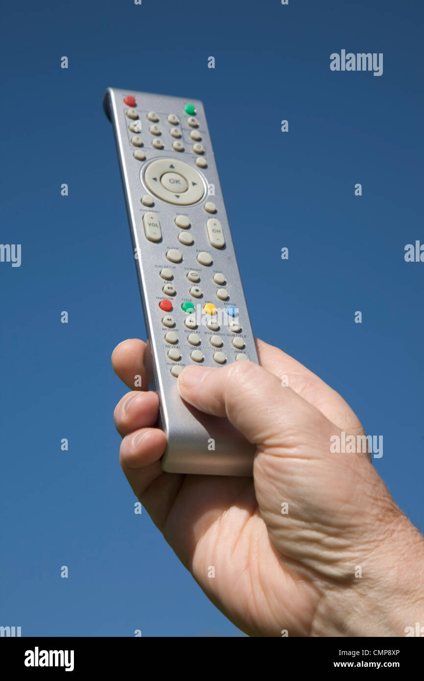 Man holding a Television remote control Stock Photo - Alamy