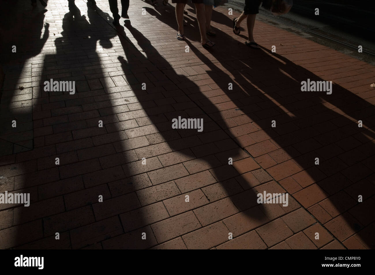 Long Shadows of Pedestrians walking on a pavement in Sydney, Australia ...