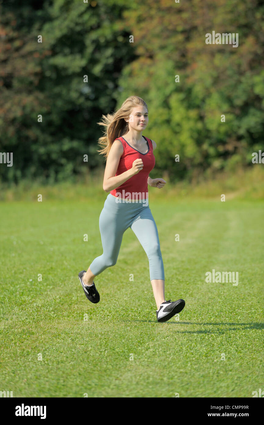 Young woman running in a meadow Stock Photo - Alamy Young woman running in a meadow Stock Photo - Alamy