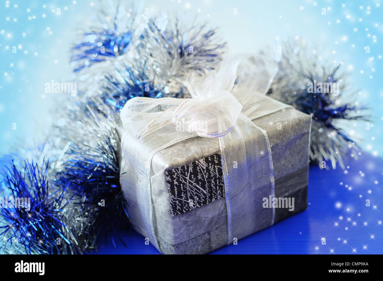 Christmas present in silver wrapping with blue decorations Stock Photo ...