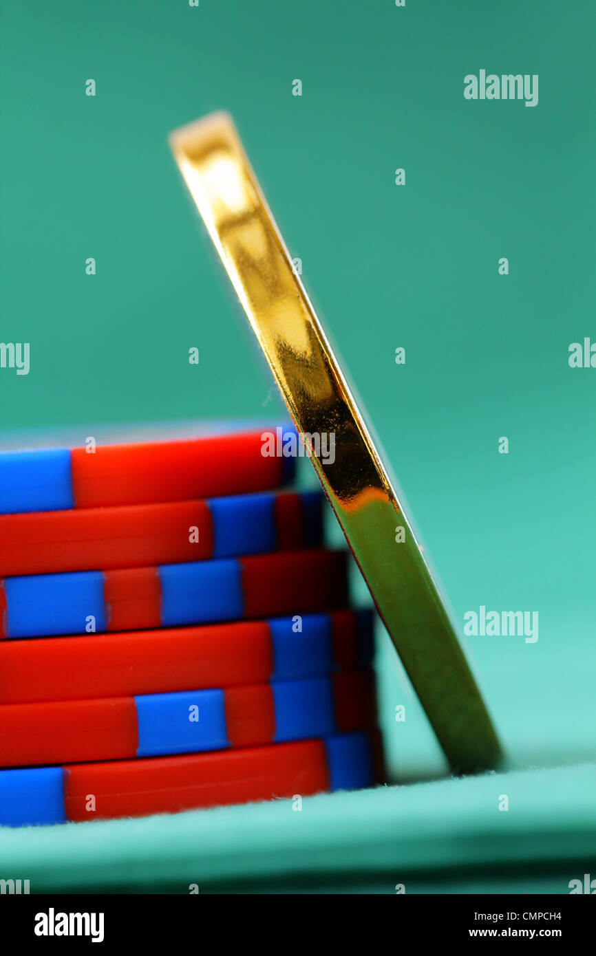 gambling chips and a gold chip on a green background Stock Photo - Alamy
