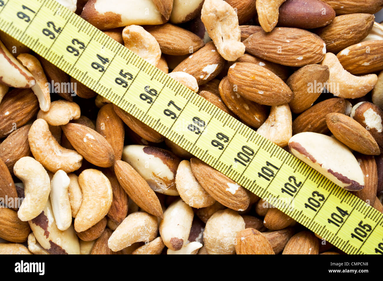 Nuts and measure tape Stock Photo - Alamy