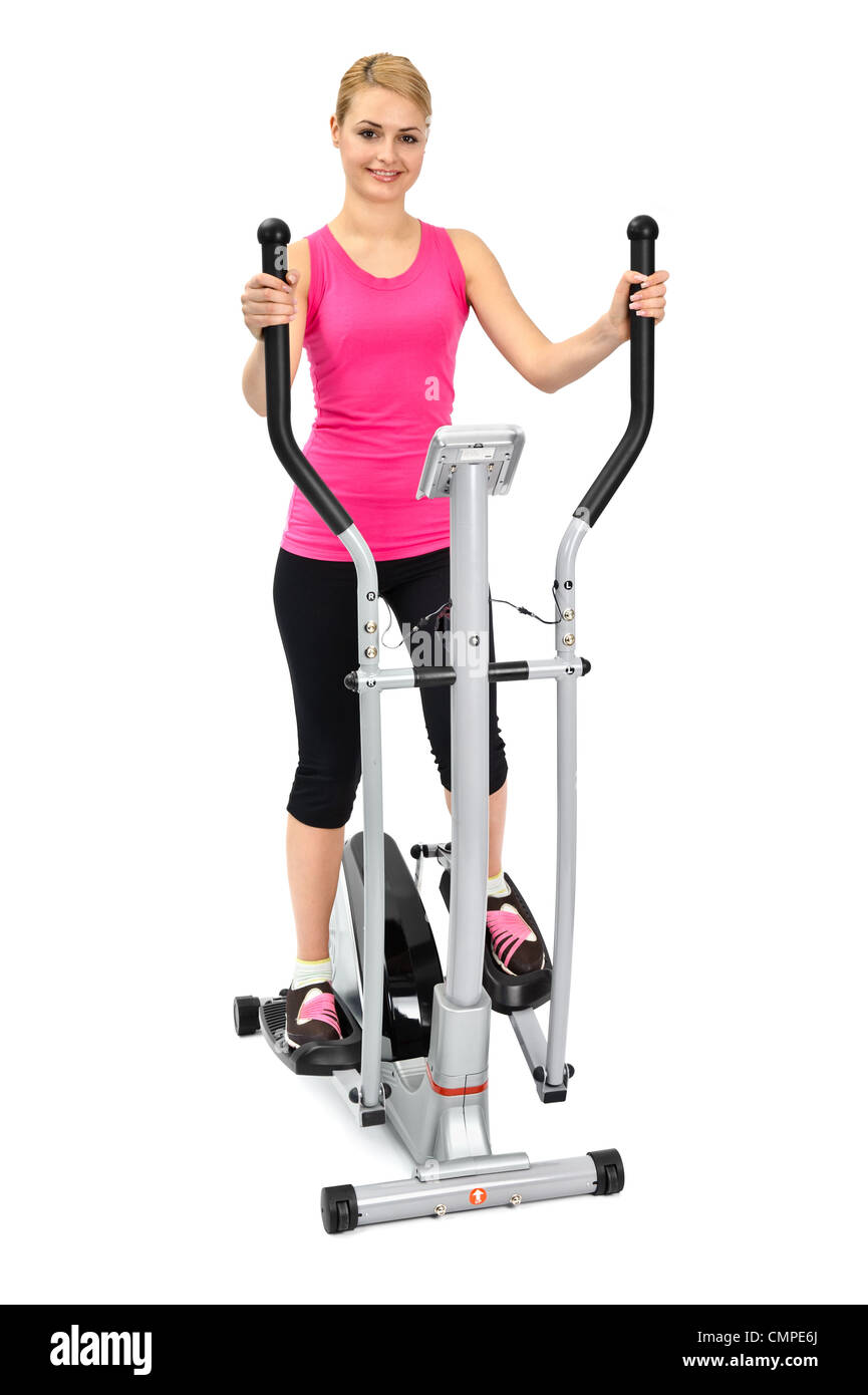 young woman doing exercises with elliptical trainer, on white ...