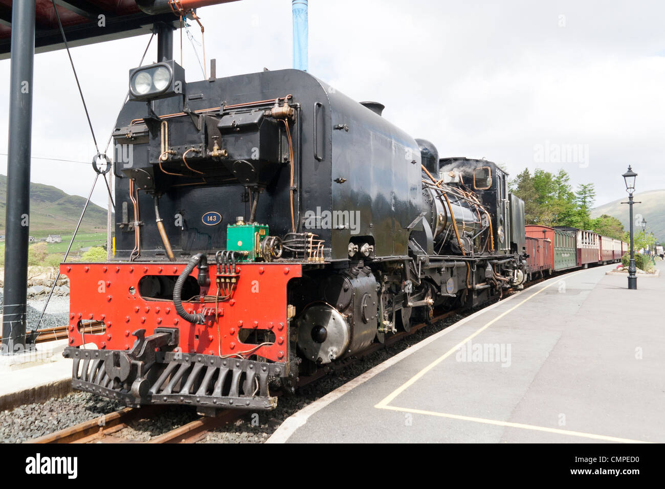 Steam locomotive pulling a passenger train on the Welsh Highland ...