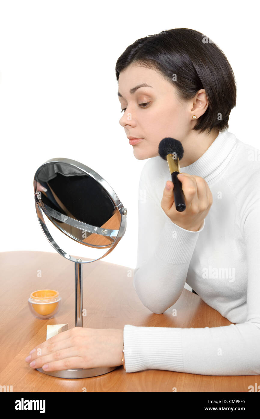 young brown eyed lady applying powder using soft brush Stock Photo - Alamy
