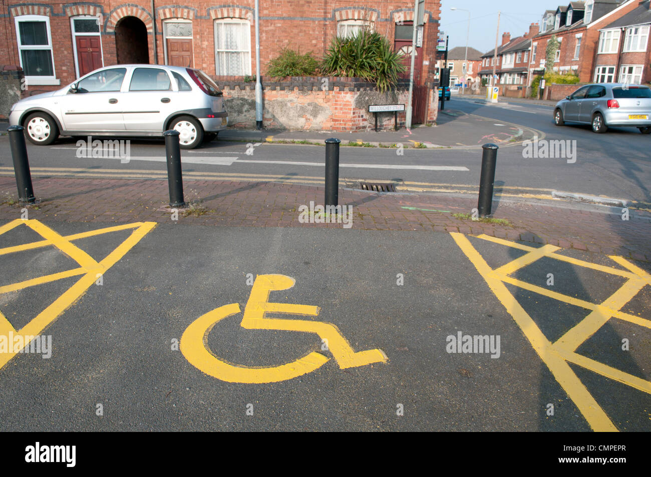 Disabled car parking space in from of suburban houses and street scene ...