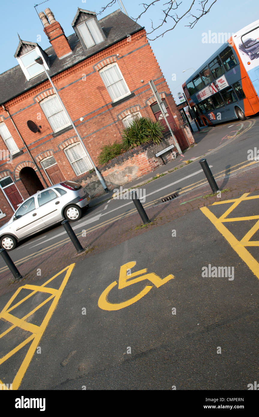 Disabled car parking space in from of suburban houses and street scene ...