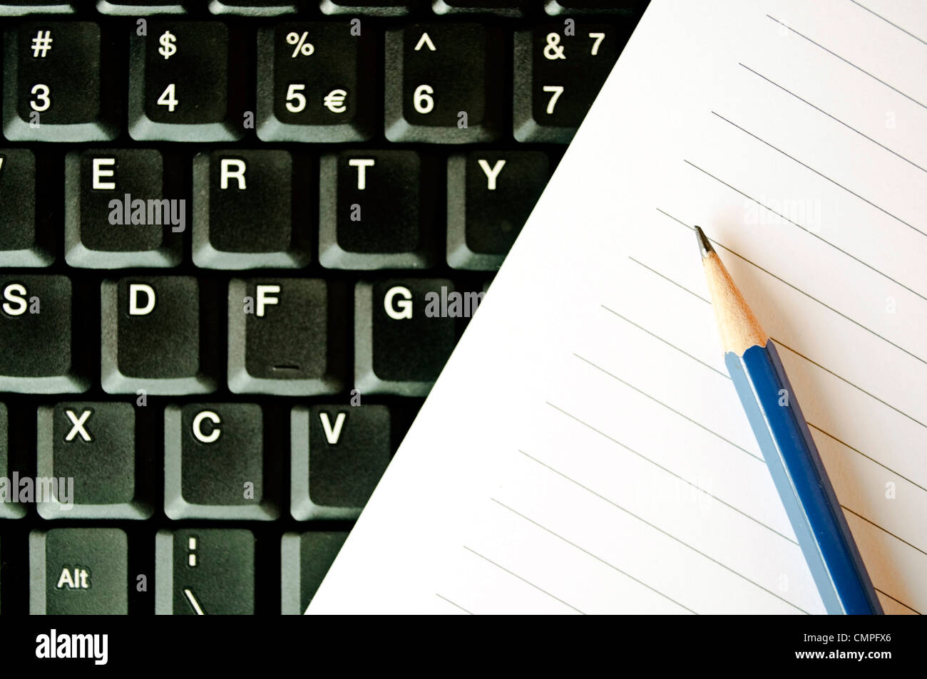 Pencil and notebook on keyboard Stock Photo - Alamy