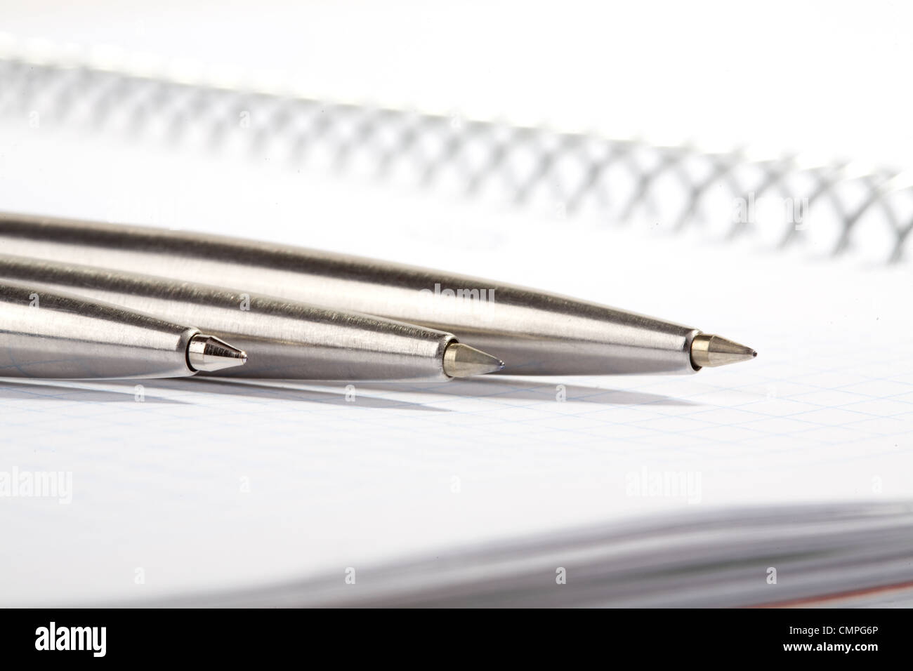 line of ball-point pens lays on a writing-book Stock Photo - Alamy