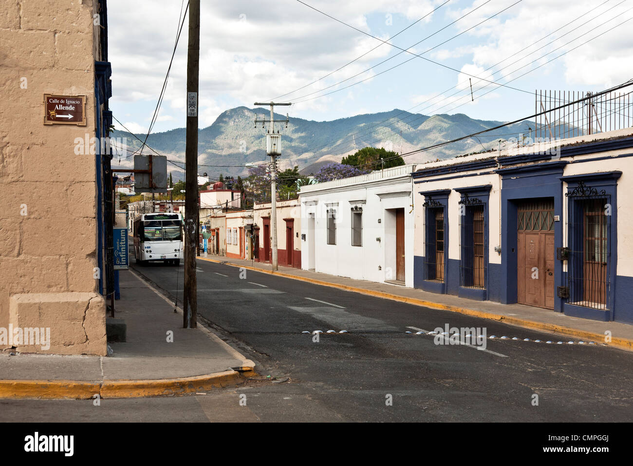 typical Mexican low scale street overshadowed by mountains in Oaxaca de ...