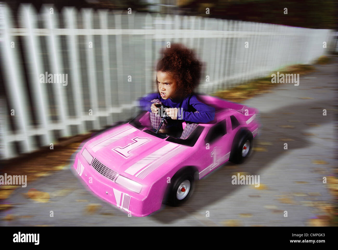 Young Girl in Pink Racing Car Stock Photo - Alamy