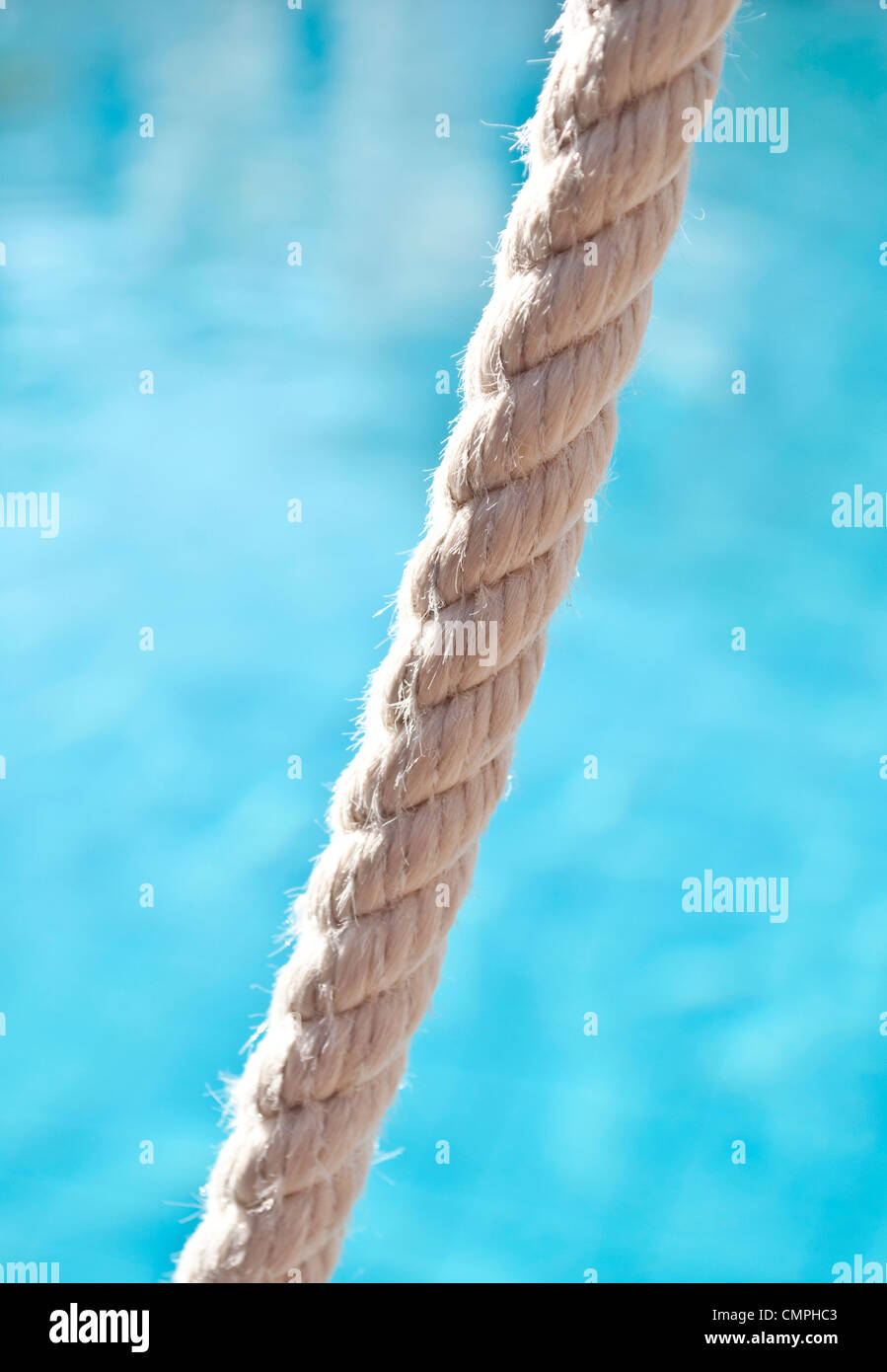 Rope against blue water Stock Photo - Alamy