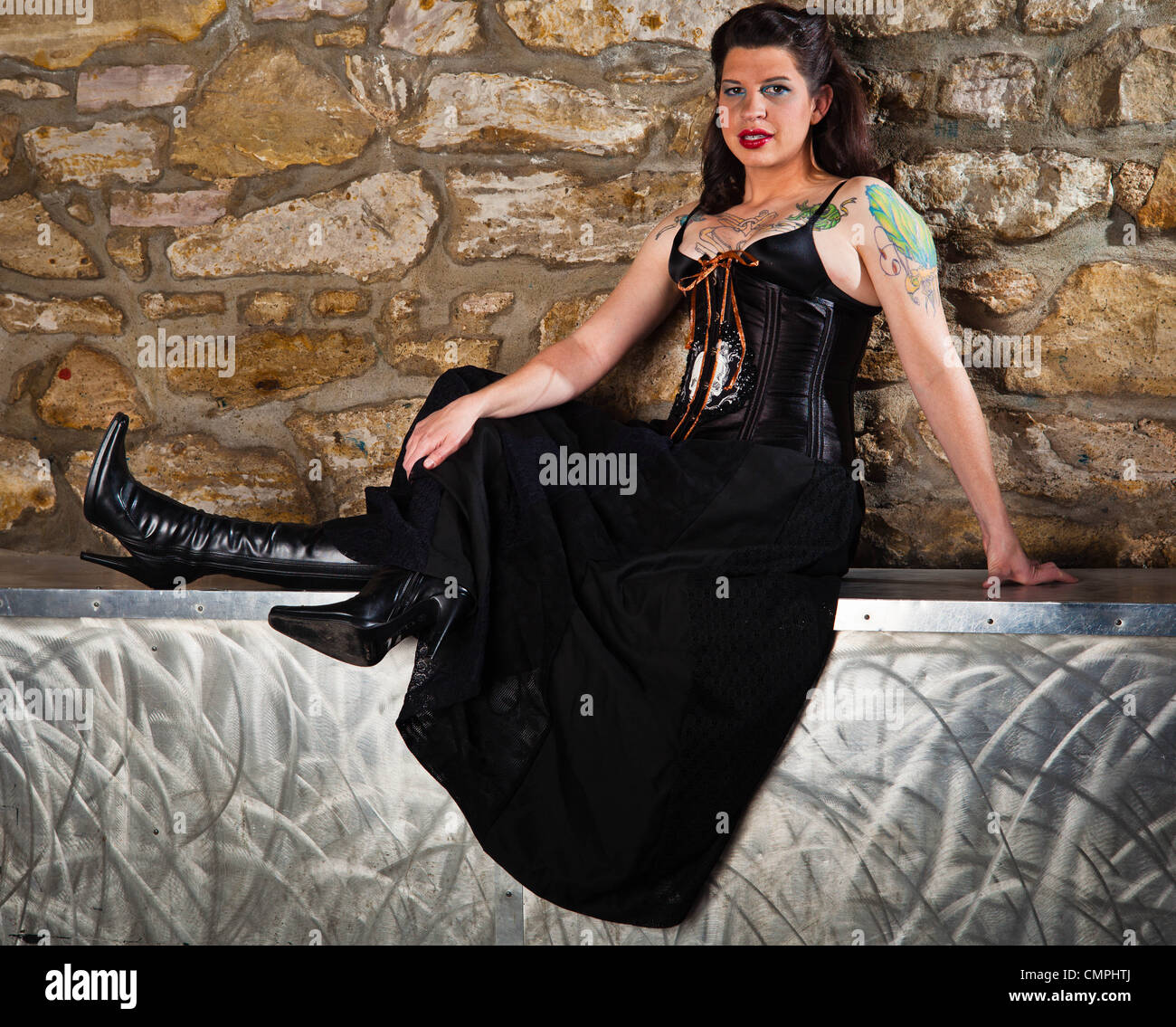 A young brunette pin up model poses in steam punk themed attire Stock ...
