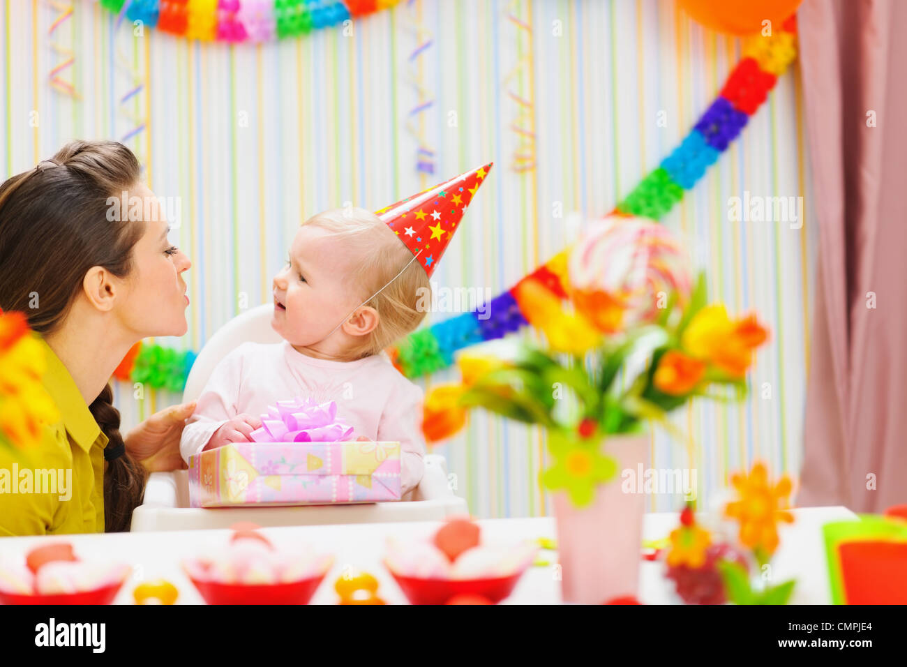 Mother giving birthday present for baby Stock Photo - Alamy