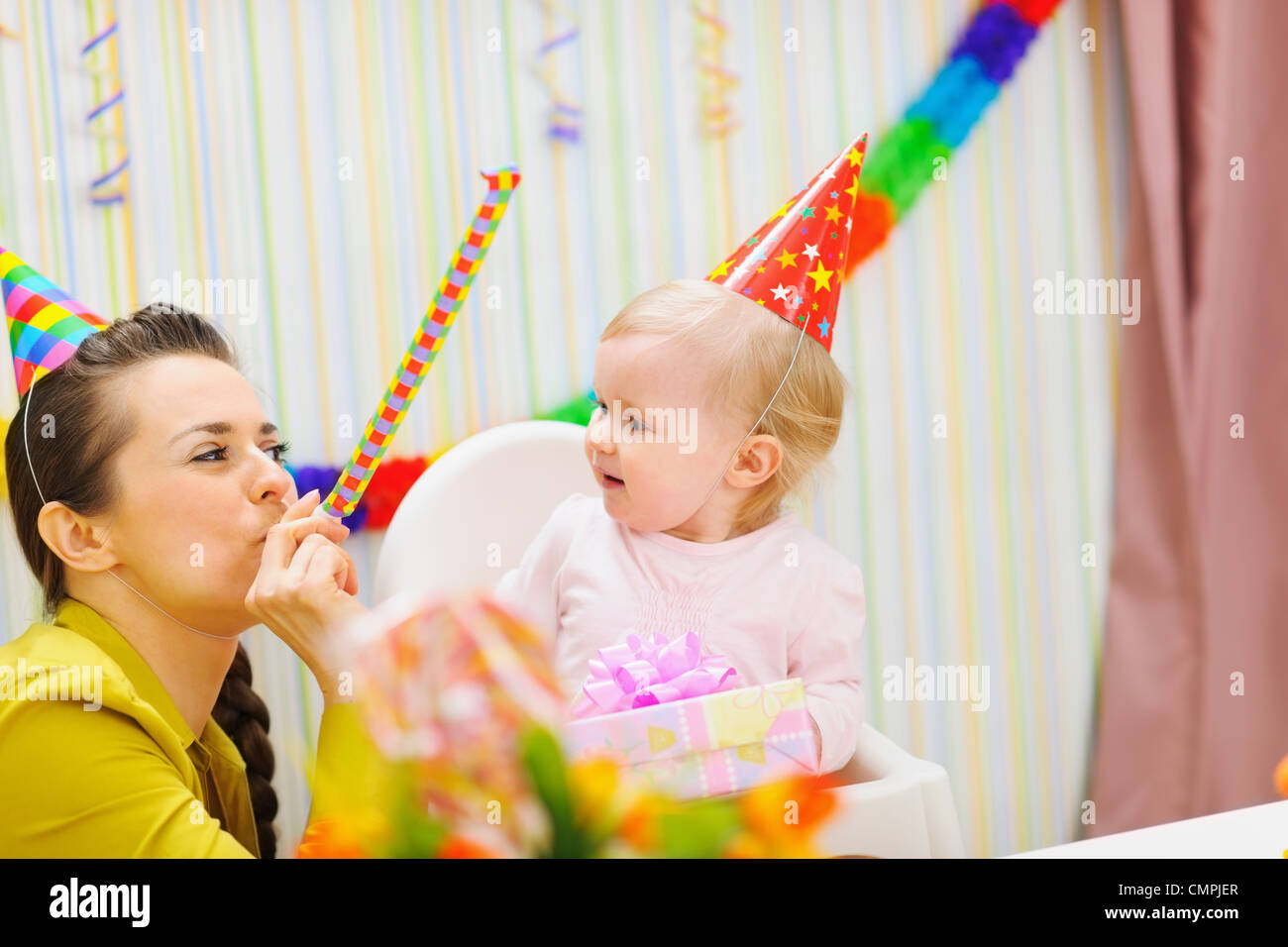 Mother and baby having fun at birthday party Stock Photo - Alamy