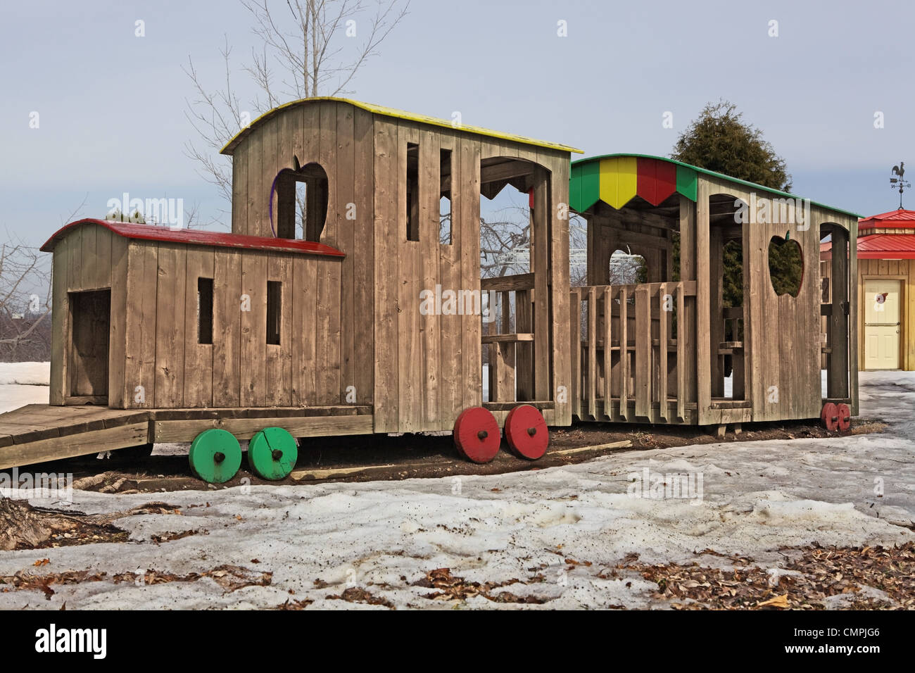 rustic wooden train structure in a playground in spring with melting ...
