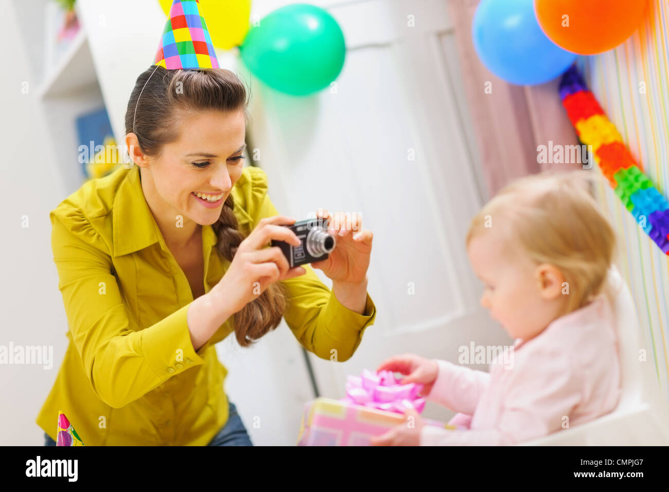 Mother making photos at babies birthday party Stock Photo - Alamy