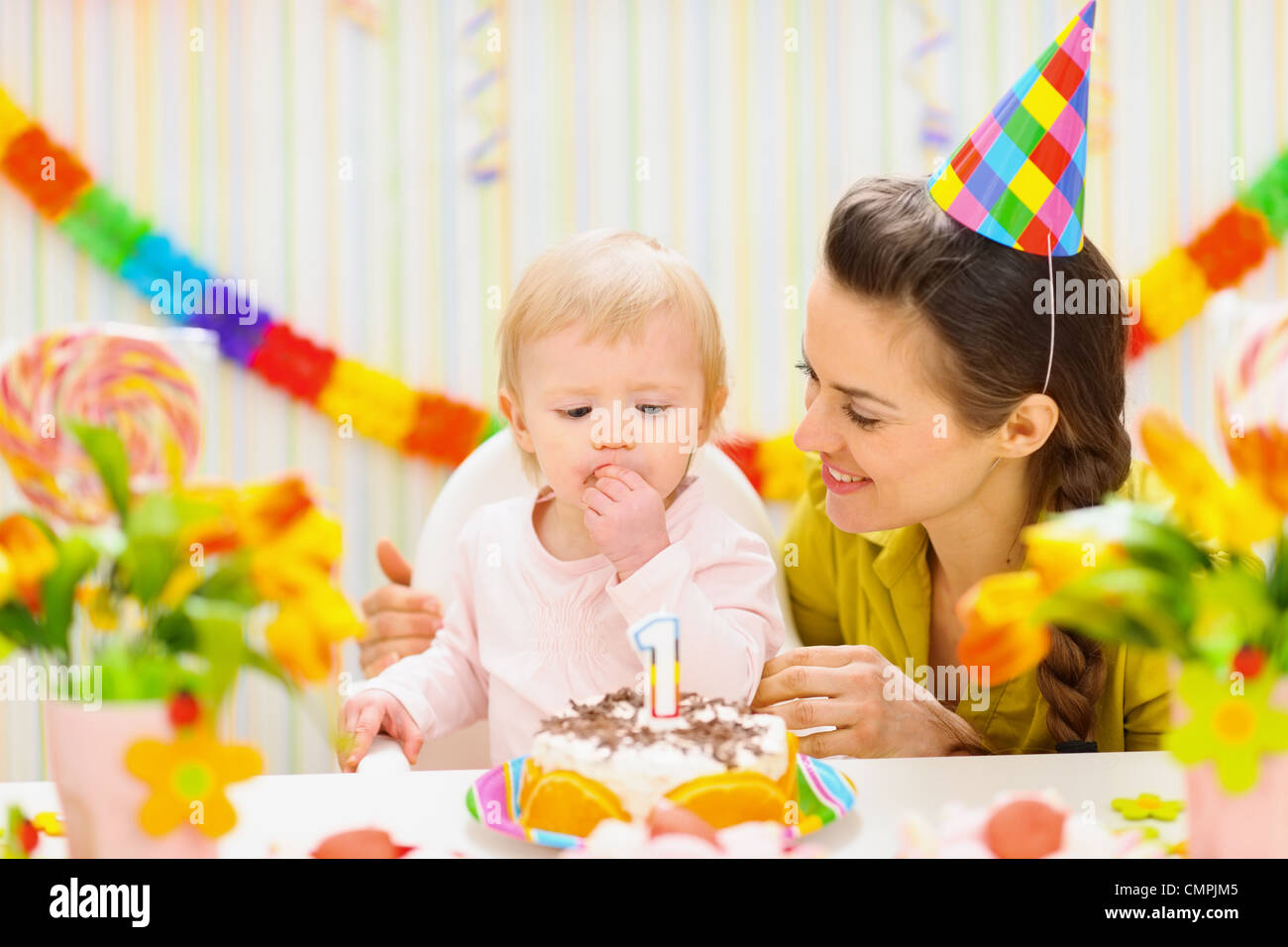 Portrait of happy mom and baby eating birthday cake Stock Photo - Alamy
