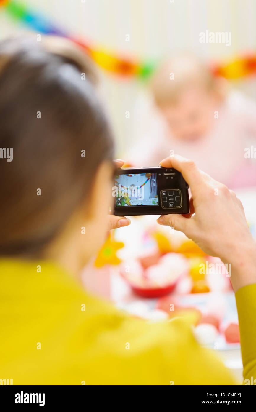 Closeup on camera on mothers hands making photos of babies first ...