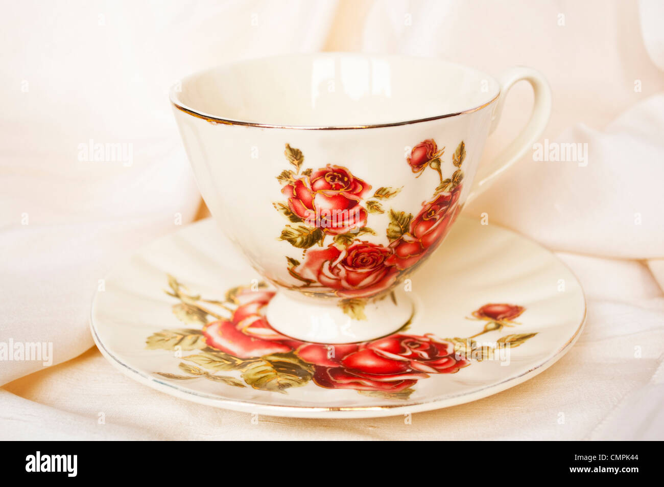 Antique tea cup with roses Stock Photo - Alamy