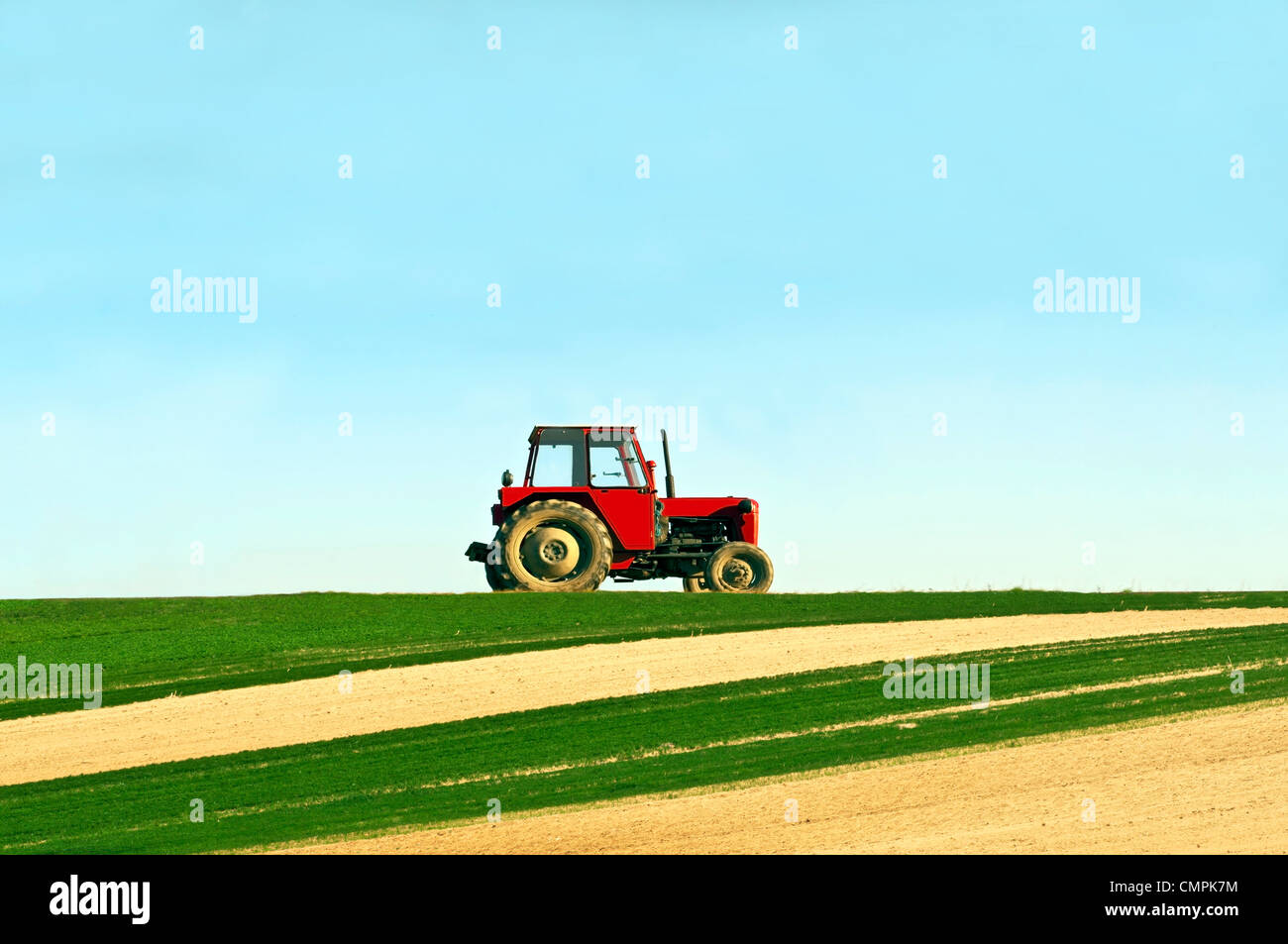 Tractor in a field - agricultural scene in summer Stock Photo - Alamy
