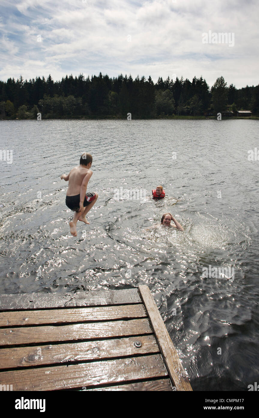Child jumping off a pier hi-res stock photography and images - Alamy