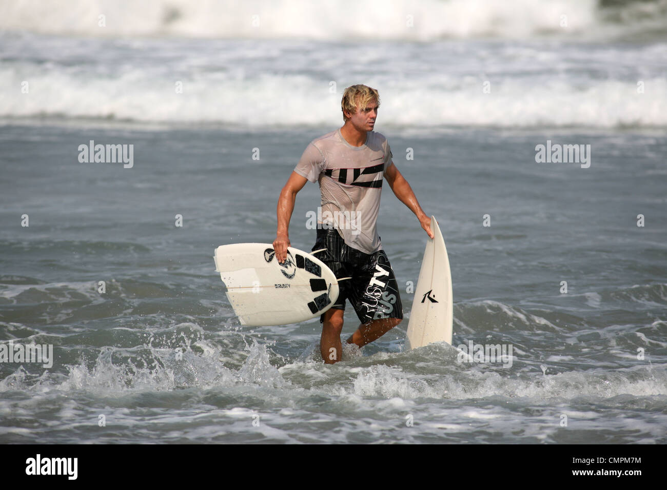 Surfer with surfboard snapped by powerful wave. Zicatela Beach, Puerto ...