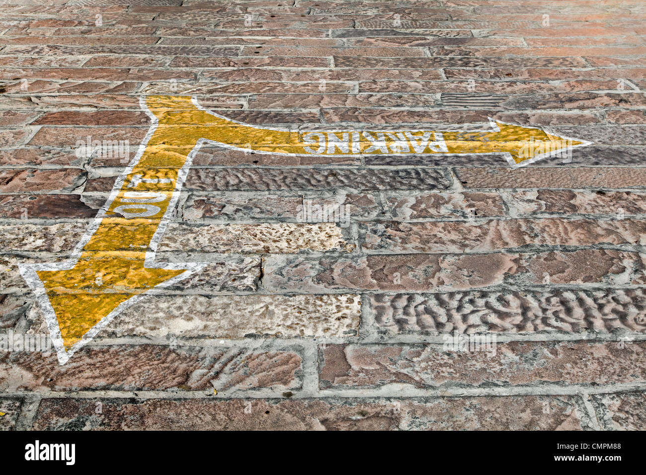 horizontal, hand painted direction arrows on cobbled stone, parking and ...