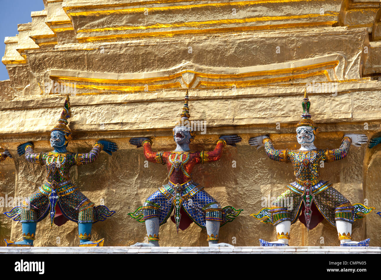 In the Wat Phra Kaew, twisted Garudas seem to support a gilded tower ...