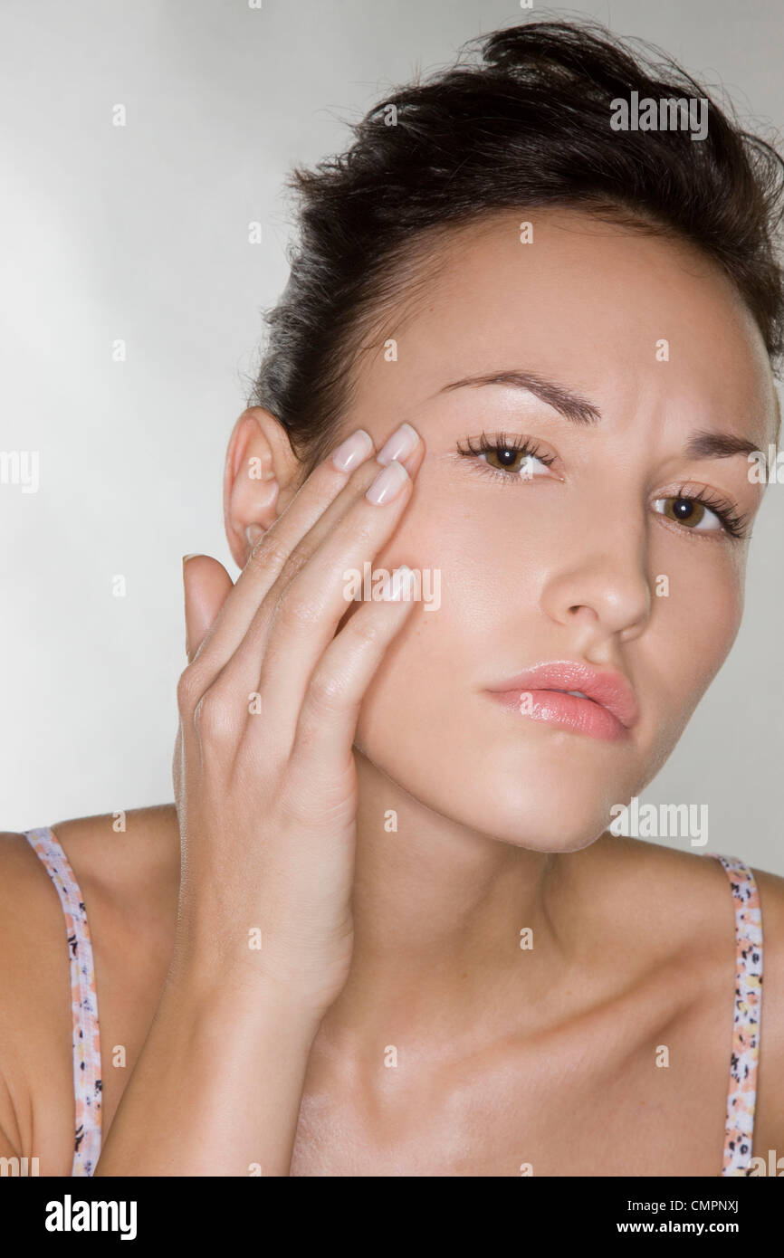 Woman examine her face Stock Photo - Alamy