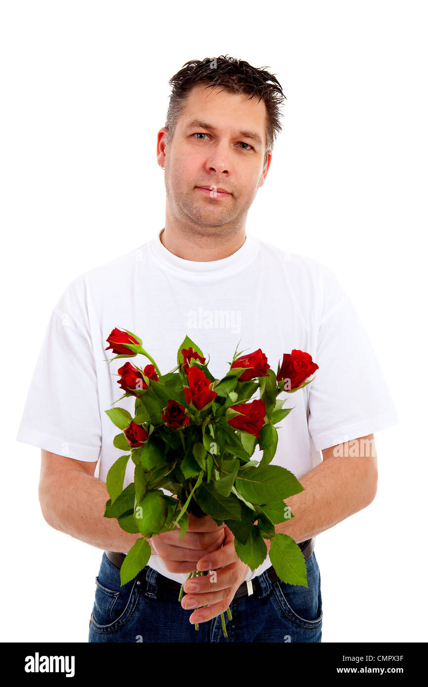 Handsome man is giving bouquet of roses over white background Stock ...