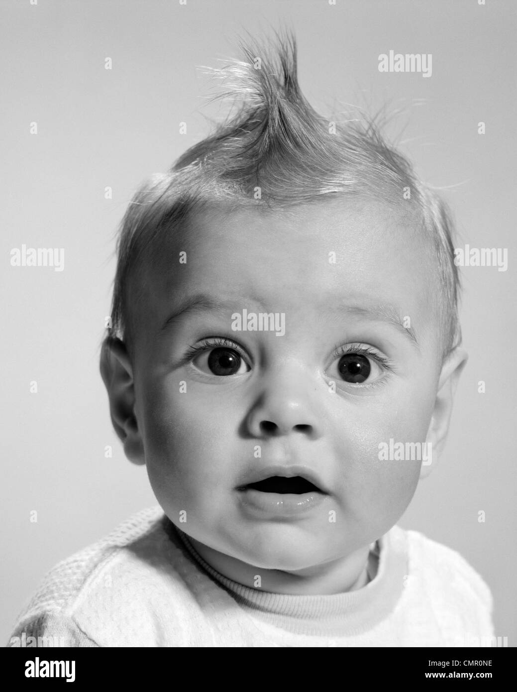 1960s CLOSE-UP PORTRAIT BABY WITH WIDE-EYED EXPRESSION WITH MOUTH OPEN ...