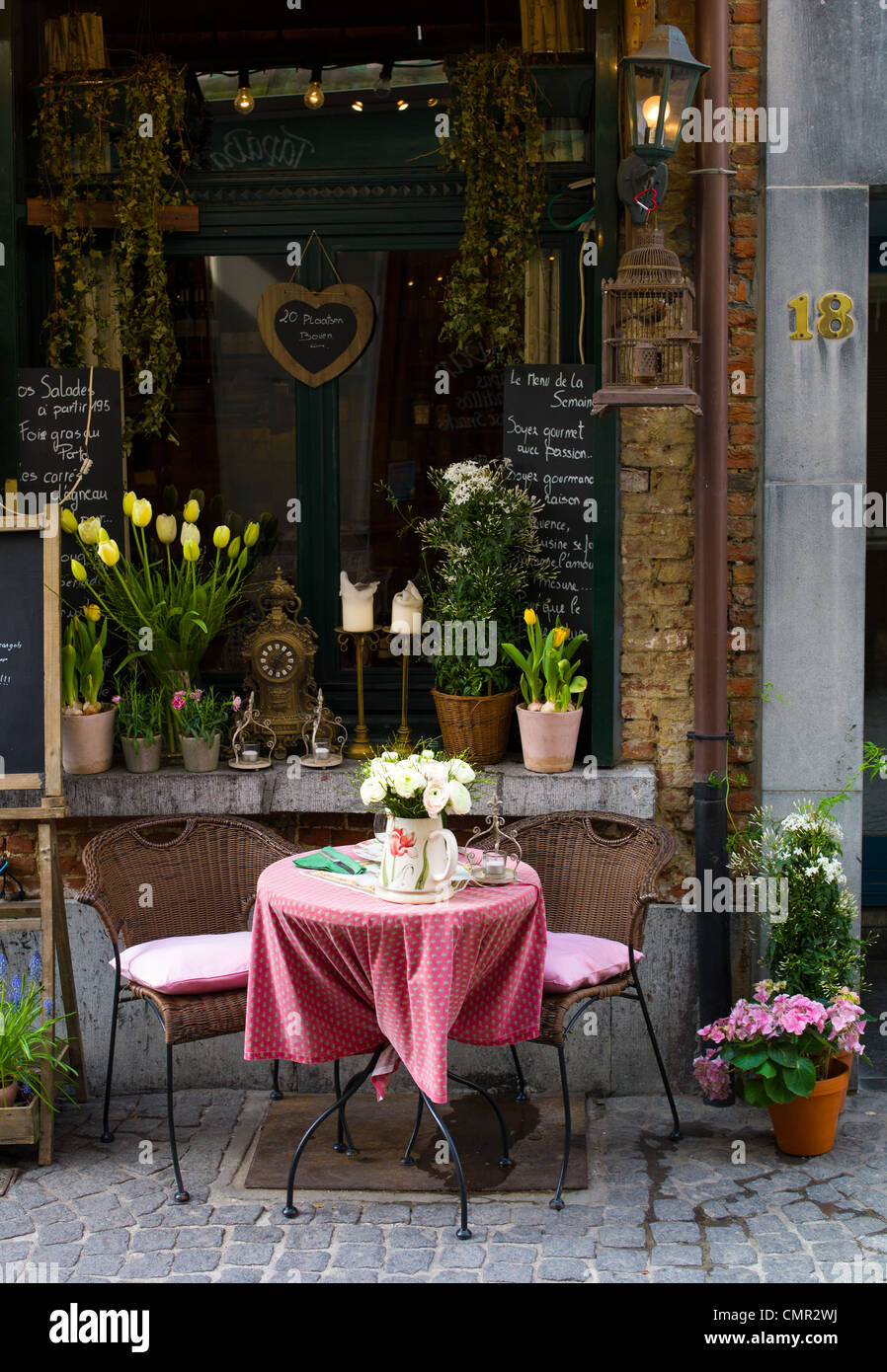 The front of a side street restaurant with table and chairs set out in ...