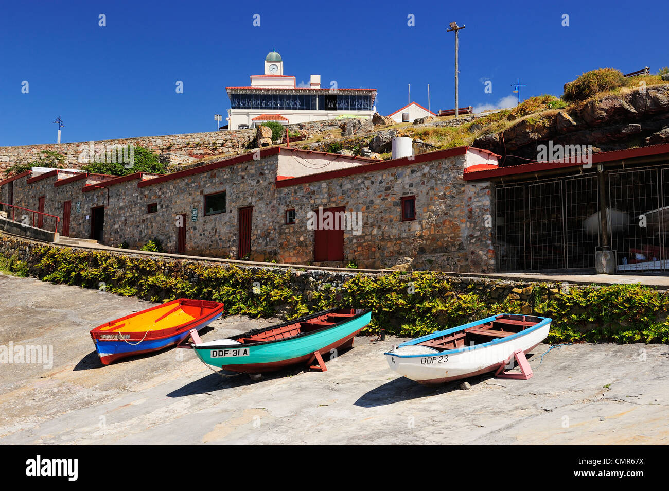 Colourful restored fishing boats in Hermanus harbour on Walker Bay ...