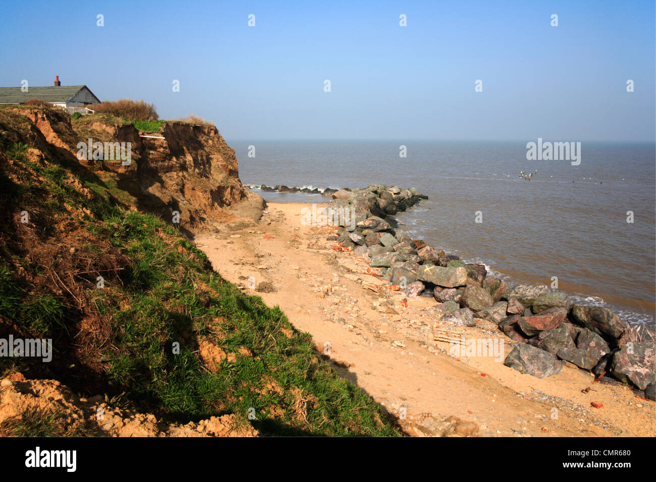 A view of the cliffs, beach, and rock sea defences at Happisburgh ...