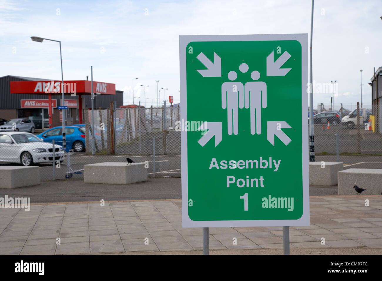 green sign for emergency assembly point at belfast international ...