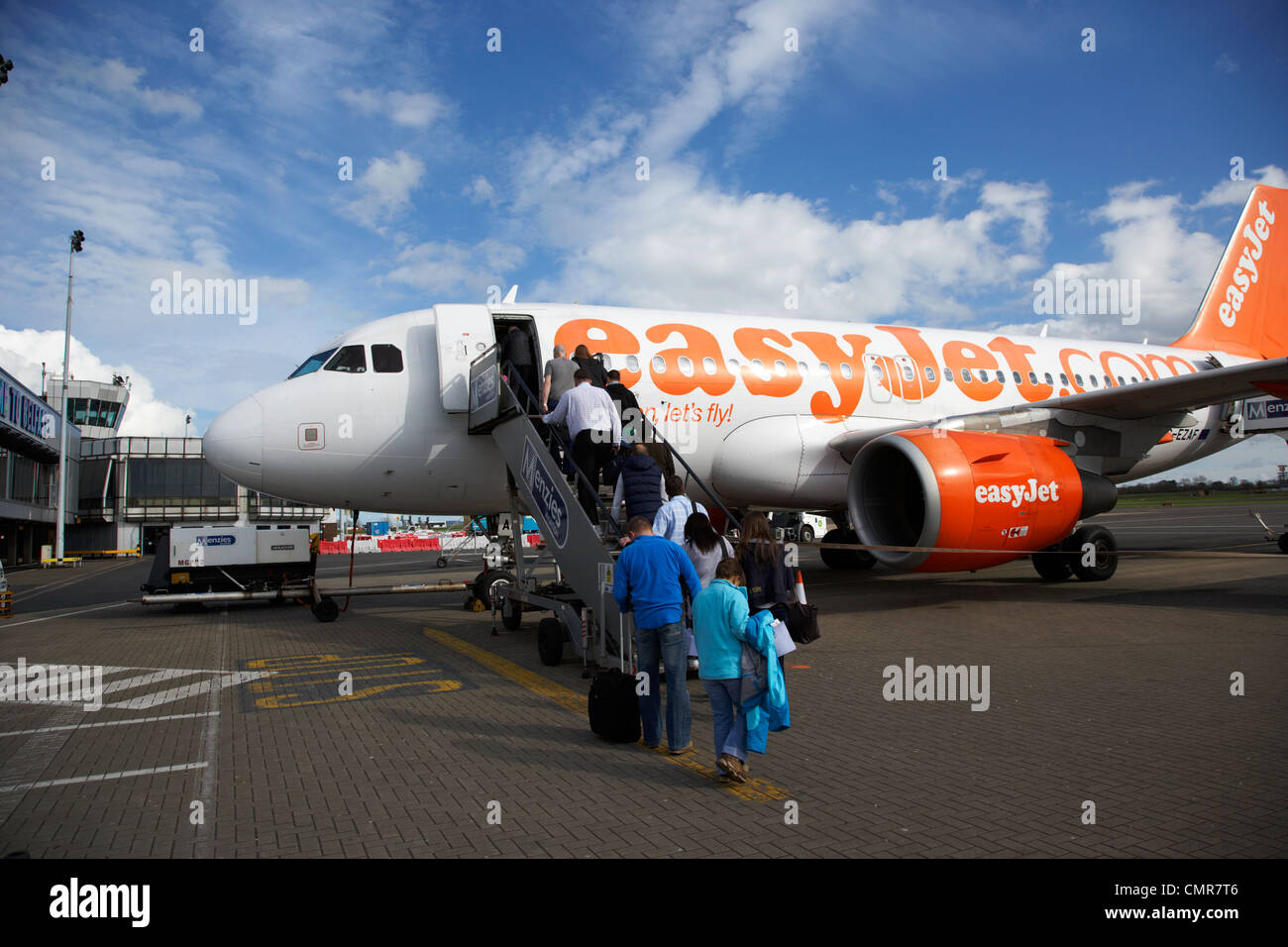 passengers boarding easyjet aircraft at belfast international airport ...