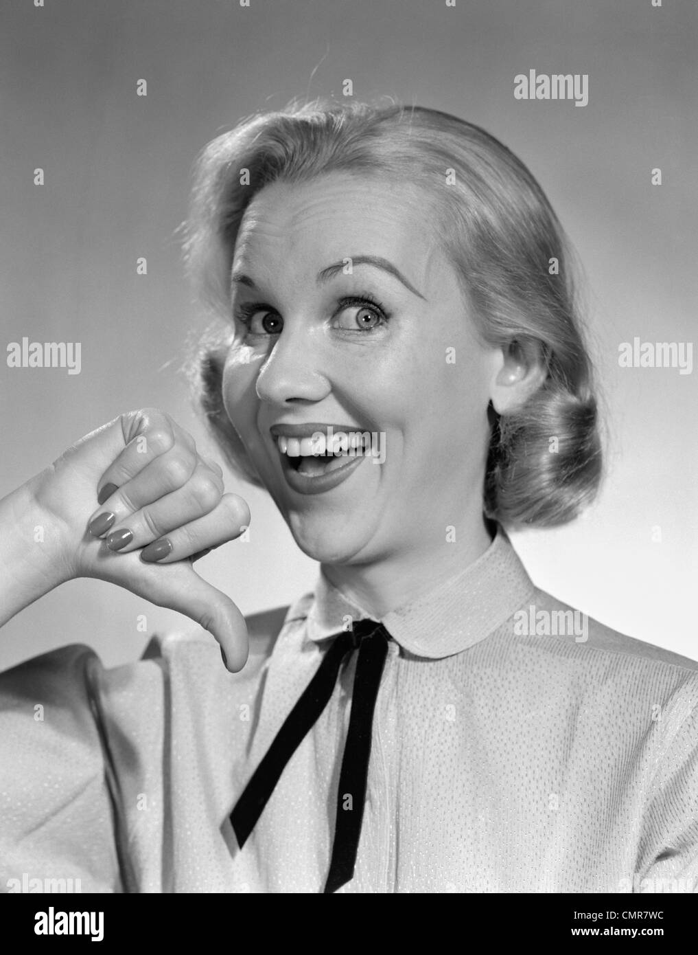 1950s WIDE-EYED SMILING BLOND PORTRAIT WOMAN POINTING TO HERSELF WITH ...