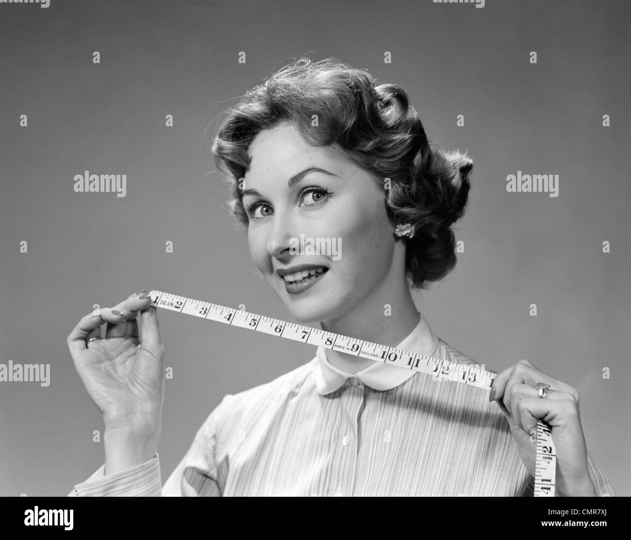 1960s WOMAN PORTRAIT HOLDING MEASURING TAPE Stock Photo - Alamy