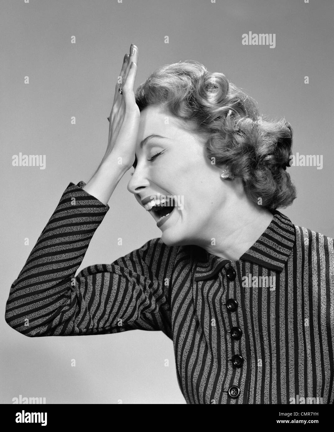 1950s WOMAN HITTING FOREHEAD WITH HEEL OF HAND AS IF SHE'S MADE A ...