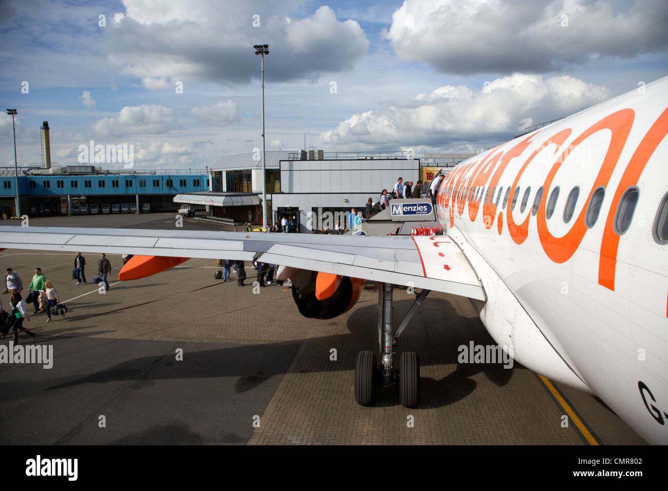 passengers boarding easyjet aircraft at belfast international airport ...