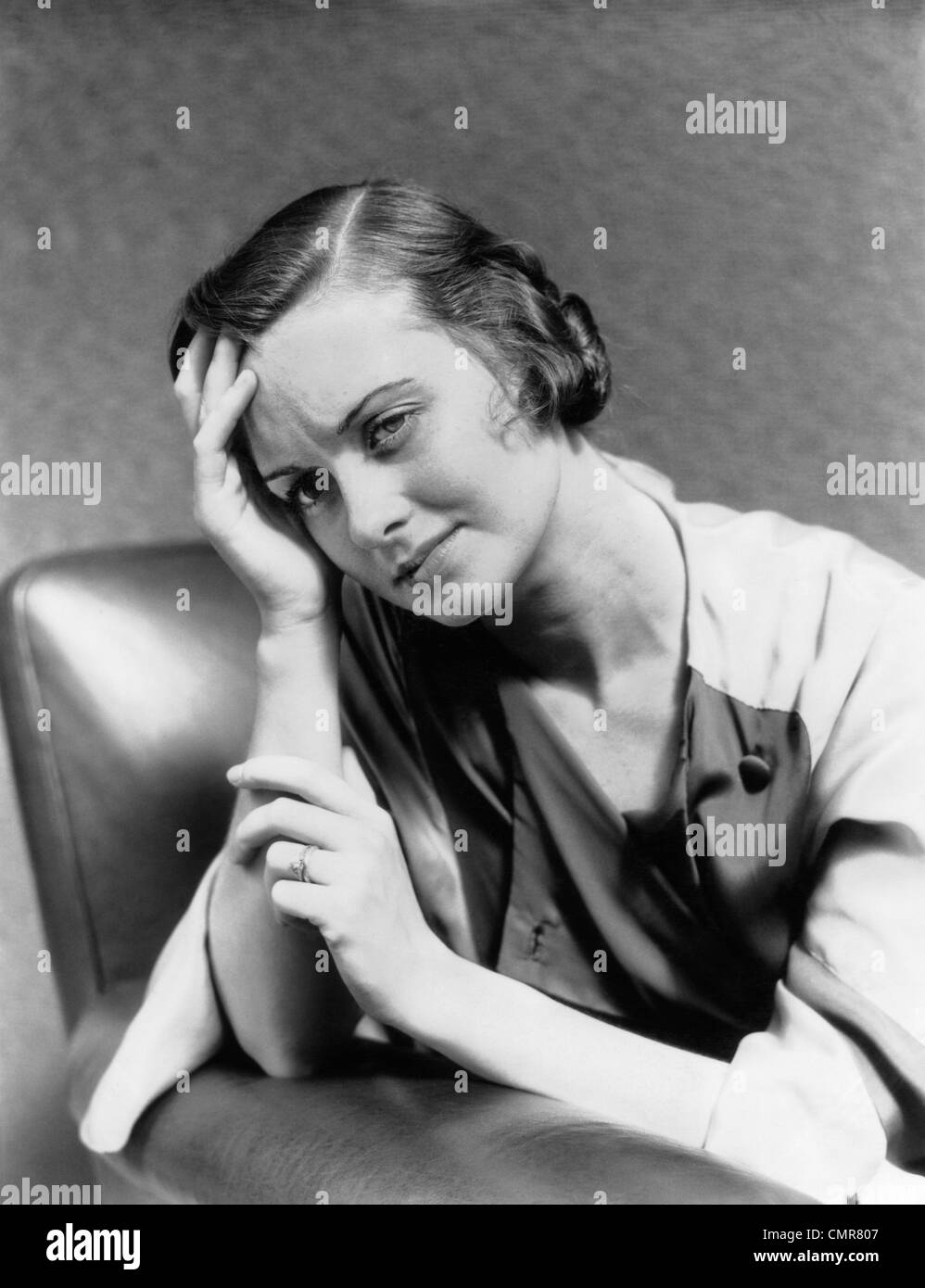 1930s 1940s WOMAN SITTING IN CHAIR WORRIED SAD EXPRESSION ONE HAND UP ... 1930s 1940s WOMAN SITTING IN CHAIR WORRIED SAD EXPRESSION ONE HAND UP ...