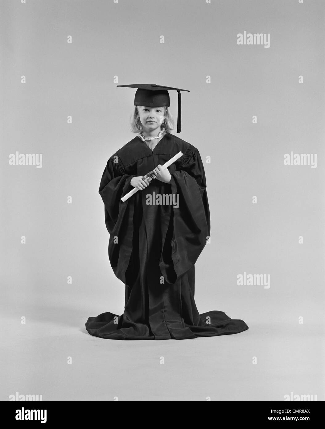 1970s GIRL WEARING GRADUATION CAP GOWN HOLDING DIPLOMA Stock Photo - Alamy