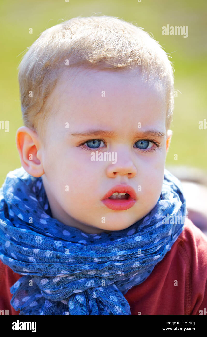Portrait of a sad little baby boy in springtime Stock Photo - Alamy